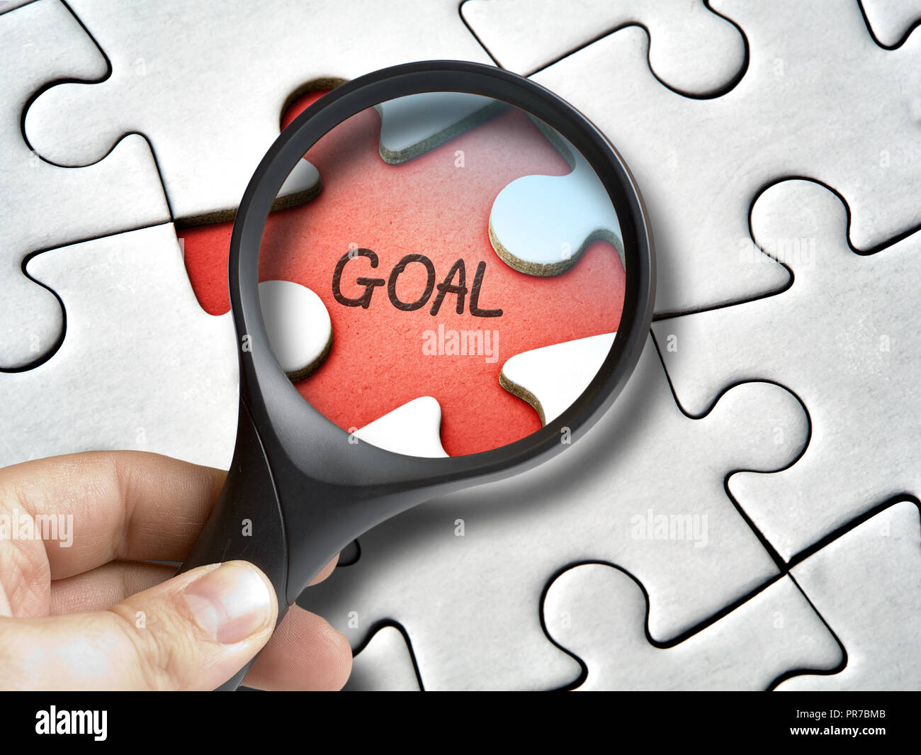 Magnifying glass on goal missing tile of the puzzle Stock Photo - Alamy