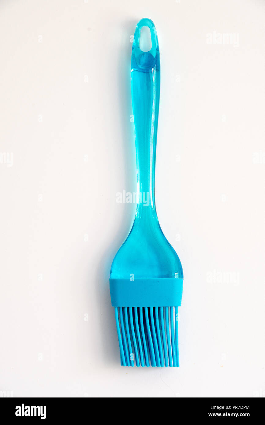 Blue plastic and silicon basting brush on a white background Stock ...