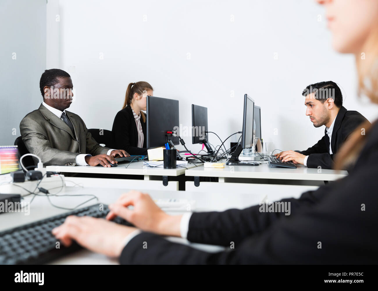 Portrait of team of diligent efficient positive buisness people working ...