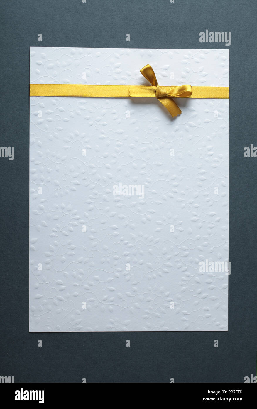 Frame with imprinted paper and golden ribbon Stock Photo - Alamy