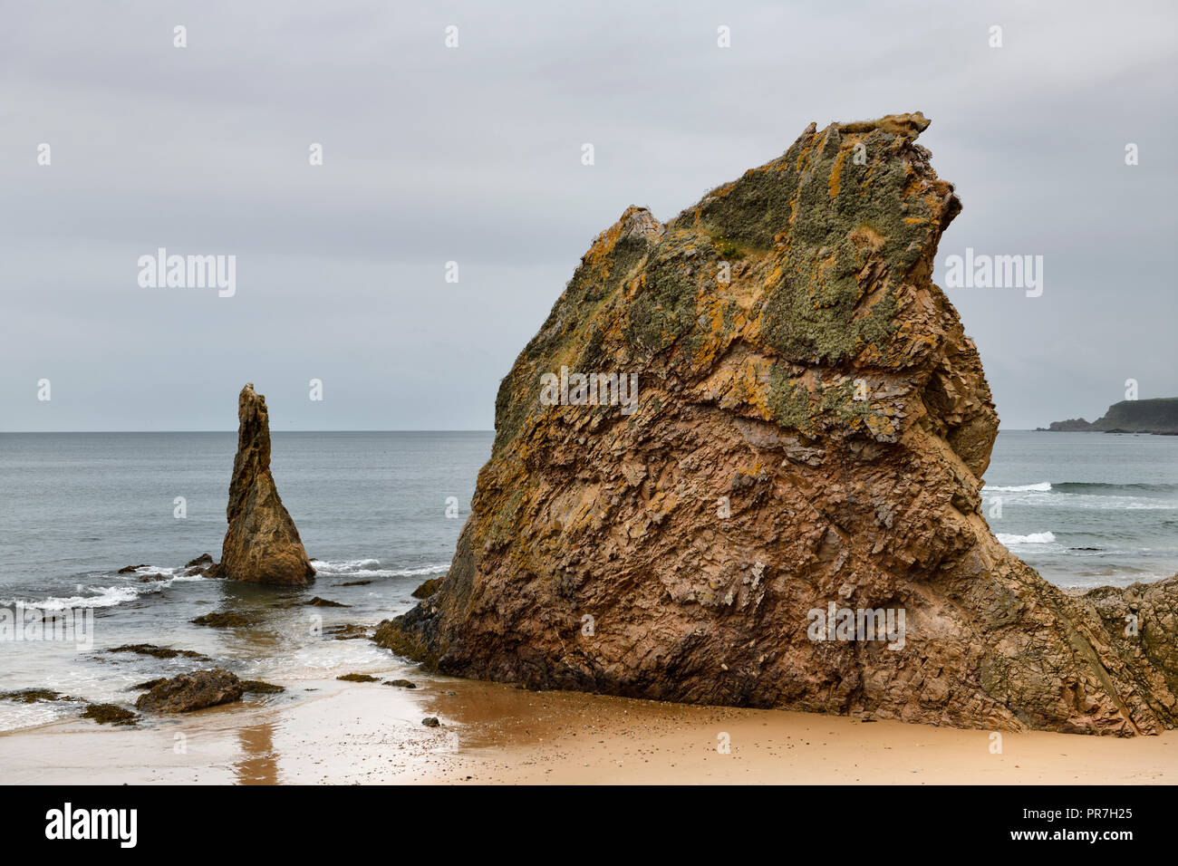 Three Kings red quartzite sea stacks on Cullen Bay beach on the North ...