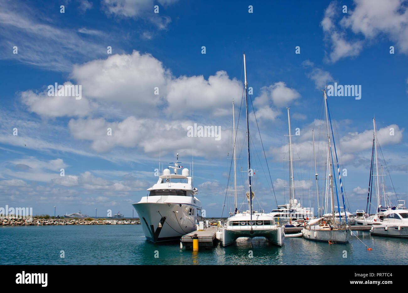 A tropical marina with white yachts and sailboats under nice sky Stock ...