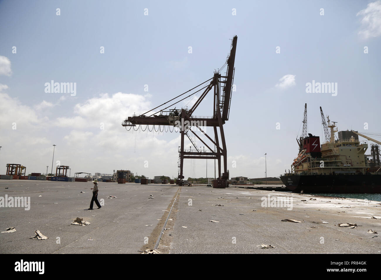Hodeidah, Yemen. 29th Sep, 2018. A man walks at the yard of the port of ...