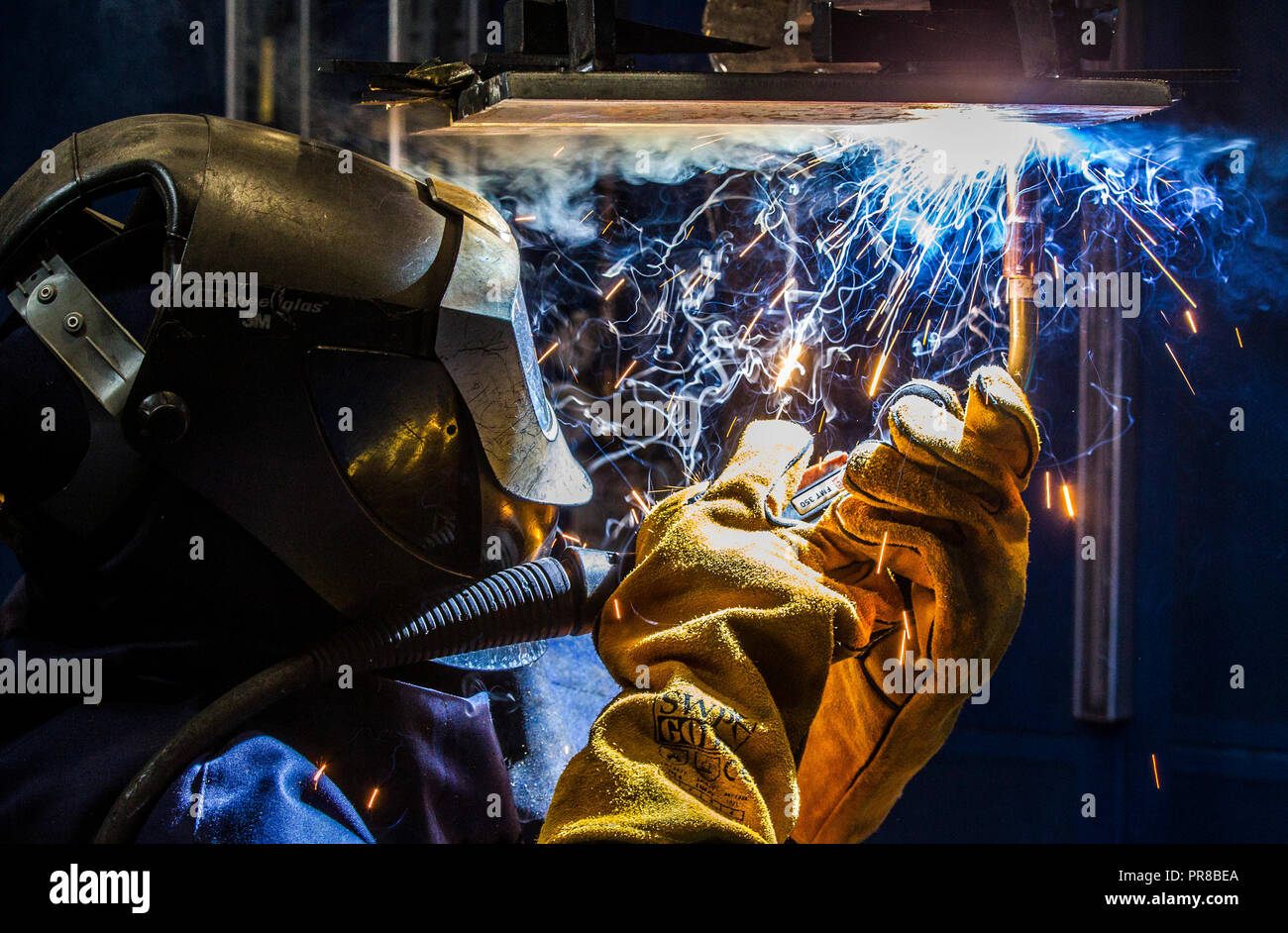 Welder wearing safety equipment welding Stock Photo - Alamy