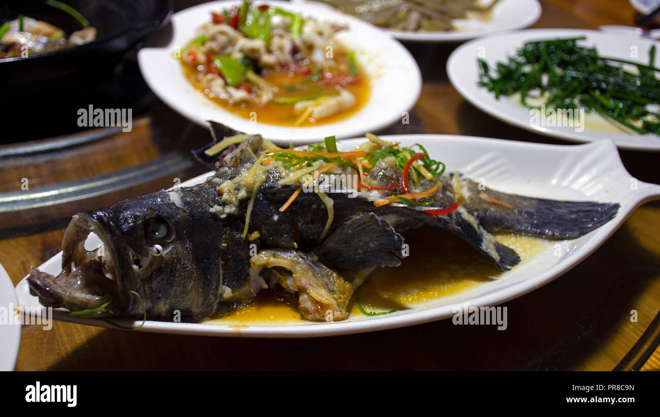 Fish served in a restaurant inside the seafood market in Haikou, Hainan ...