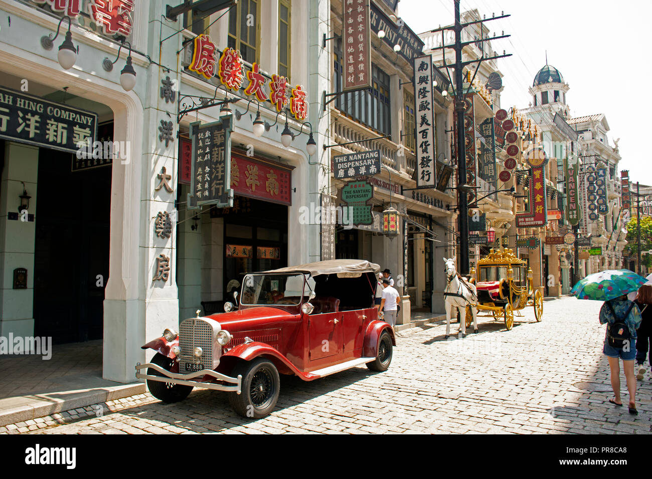 An old car parked in front of prop buildings representing old colonial ...