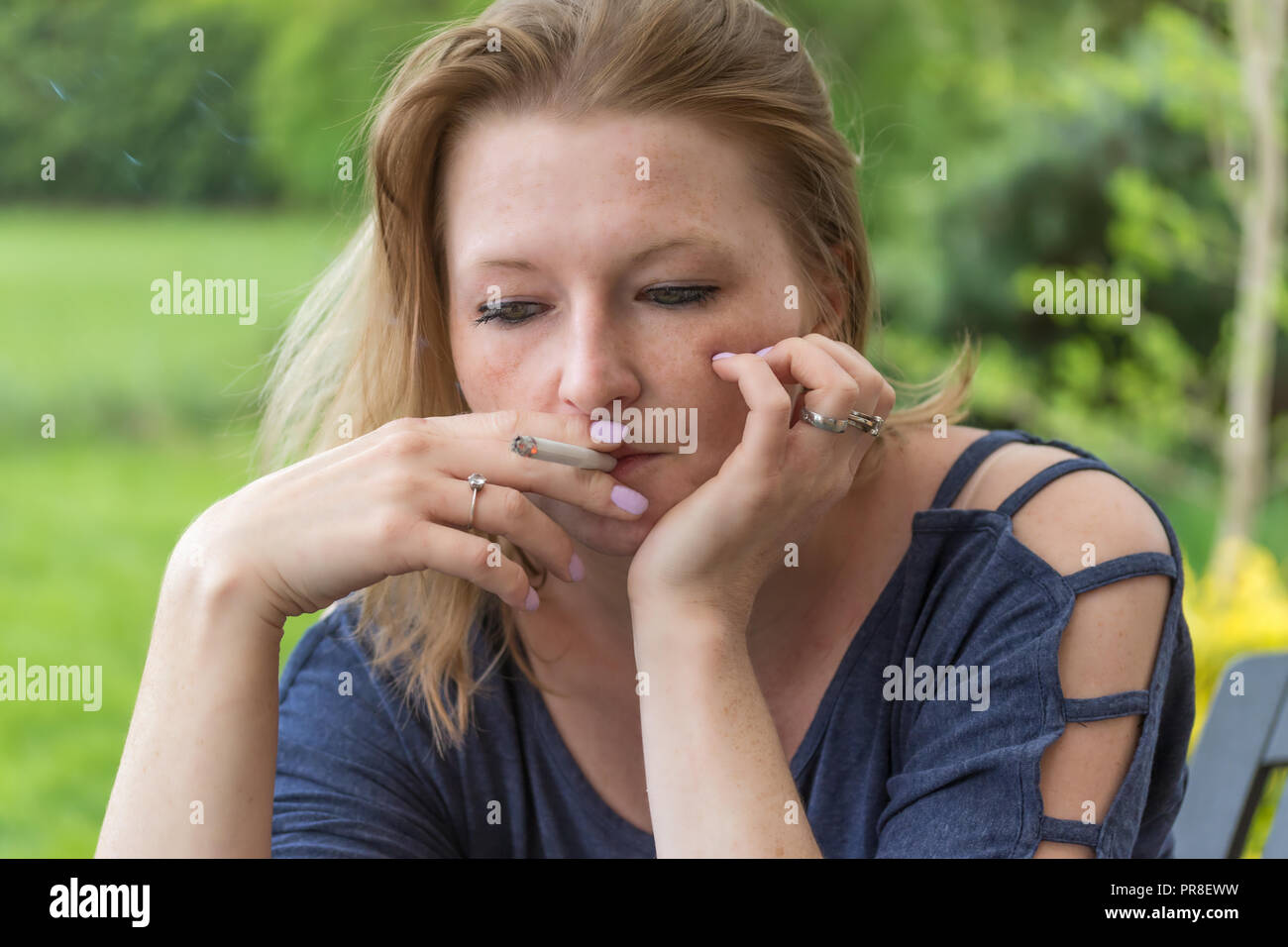 Brunette smoking cigarette hi-res stock photography and images - Alamy