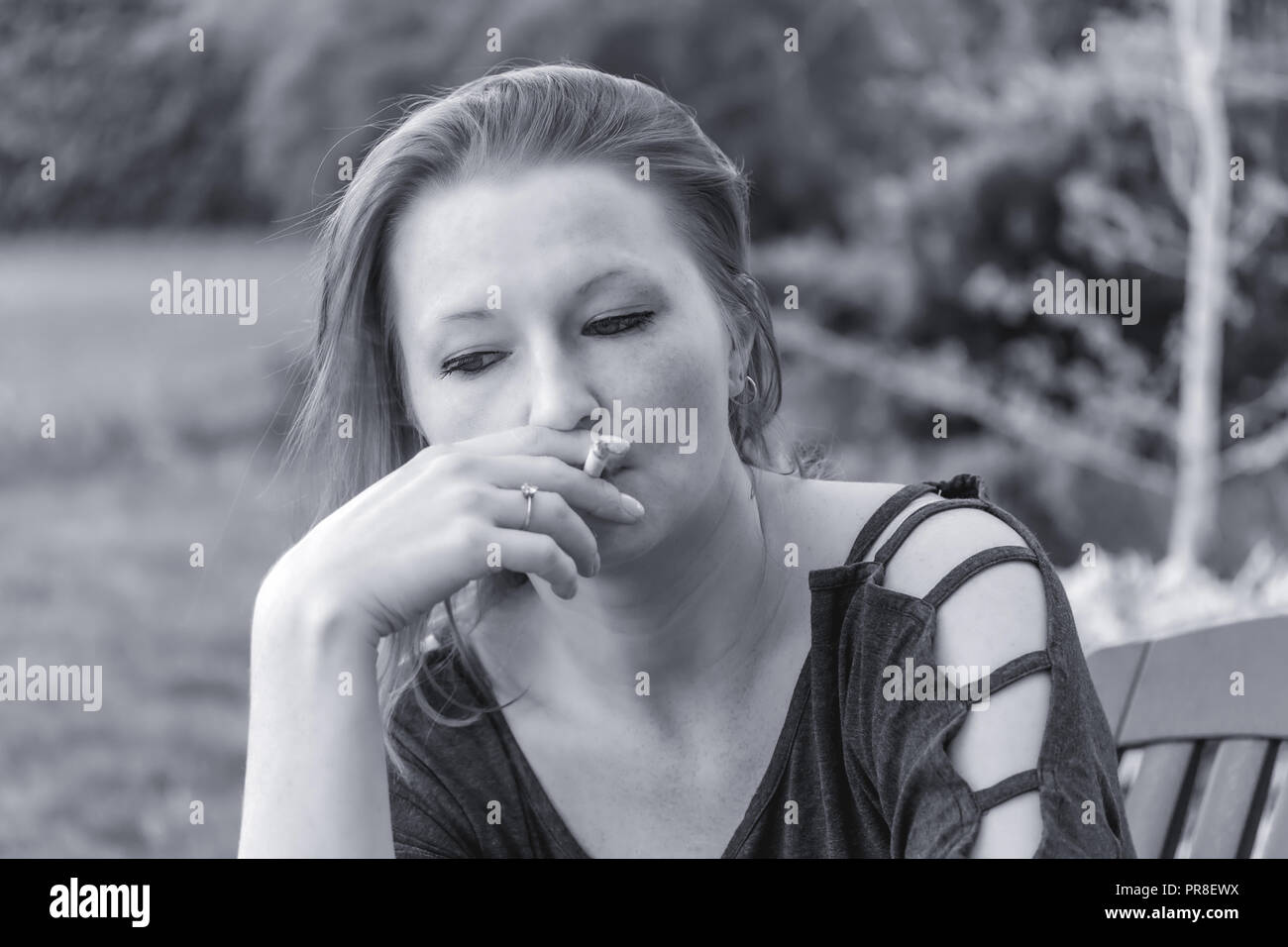 Brunette smoking cigarette hi-res stock photography and images - Alamy