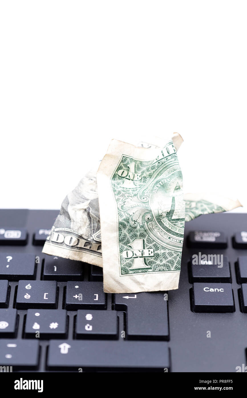 blurred crumpled dollar money background in a keyboard like concept of ...