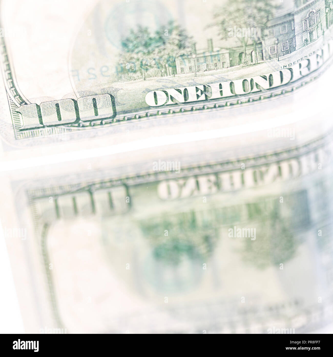 blurred dollar money background and mirror like concept of success ...