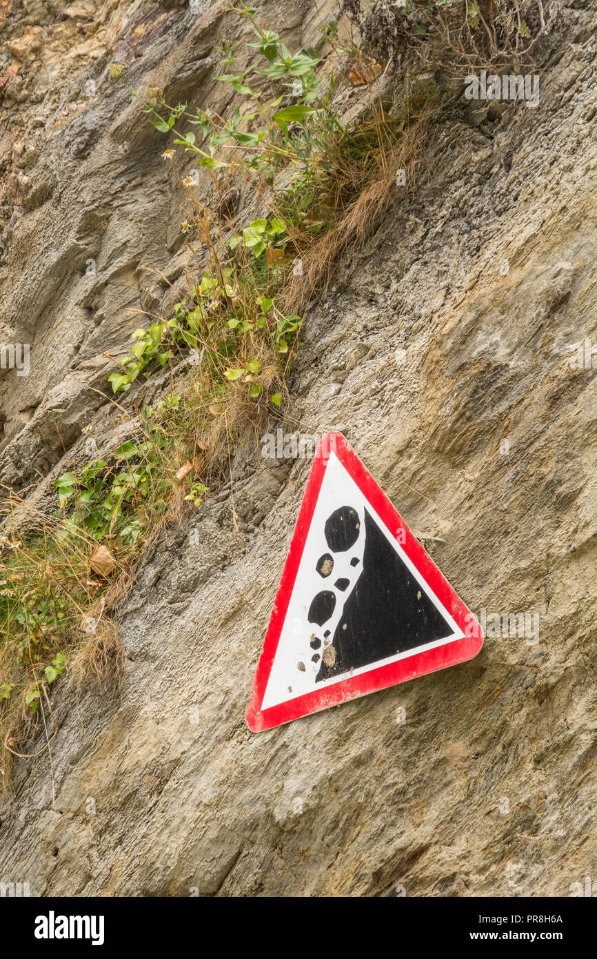 Coastal scene around Newquay, Cornwall. Beware of falling rocks warning ...