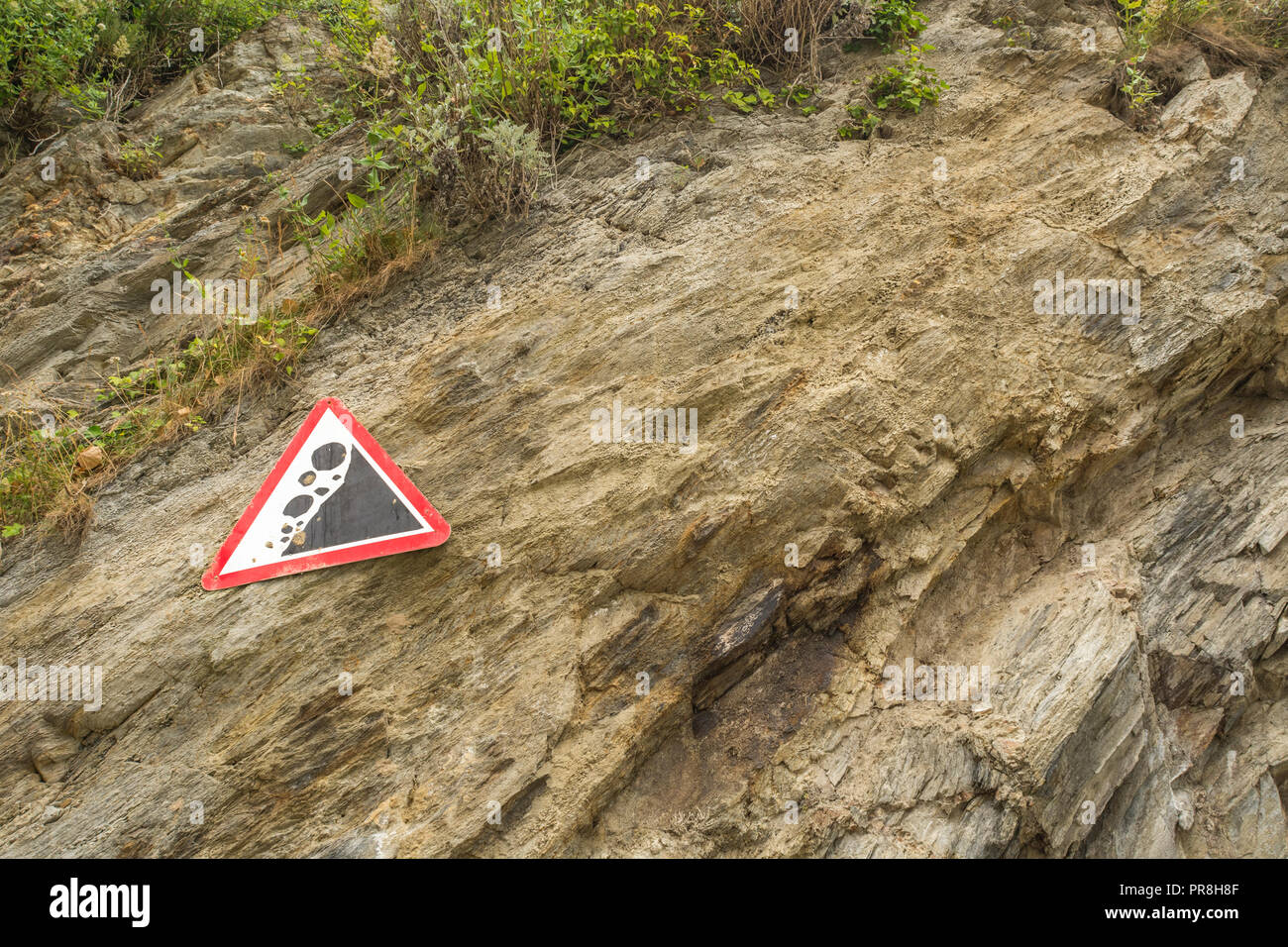 Coastal scene around Newquay, Cornwall. Beware of falling rocks warning ...