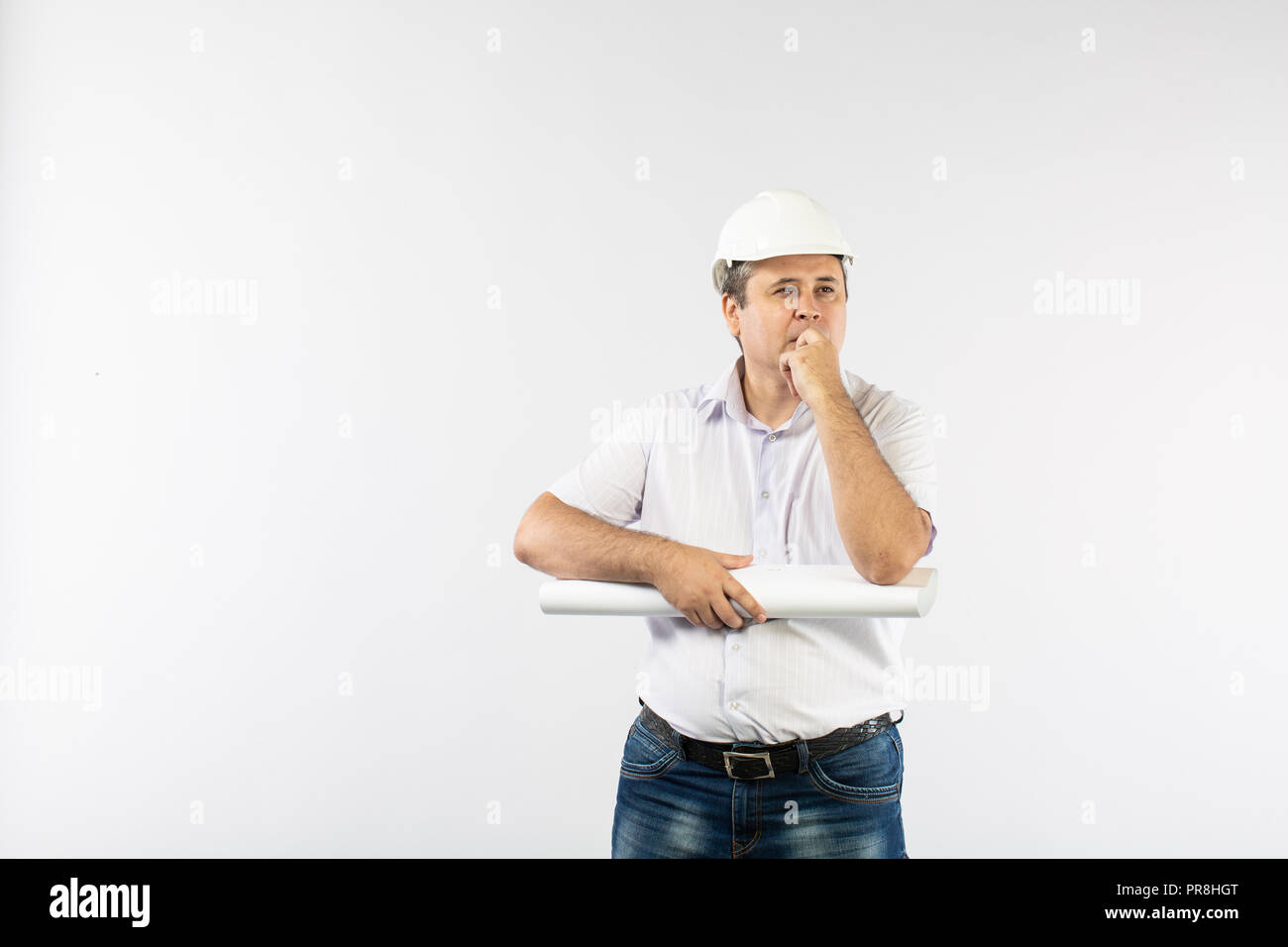 rortrait of senior architect holding plans and wearing security helmet ...