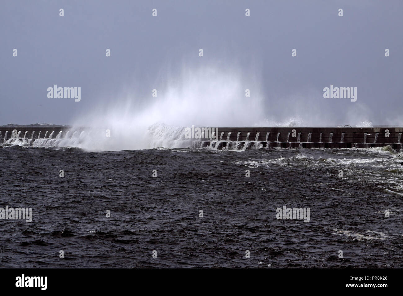 Big ocean waves over pier in a windy day Stock Photo - Alamy