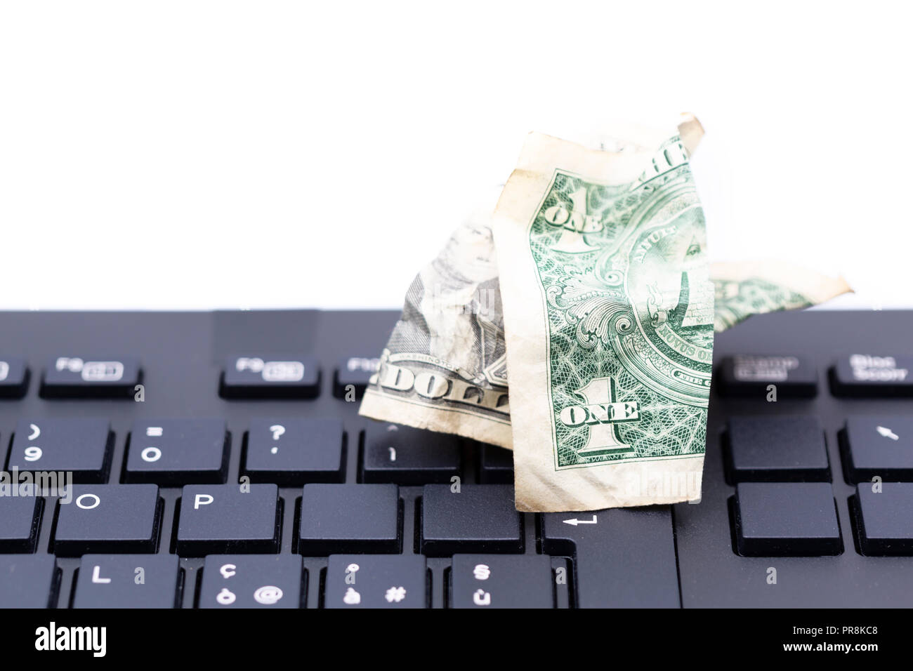 blurred crumpled dollar money background in a keyboard like concept of ...