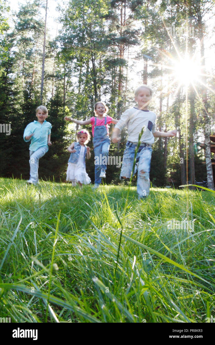 Group of young children running towards camera in park Stock Photo - Alamy