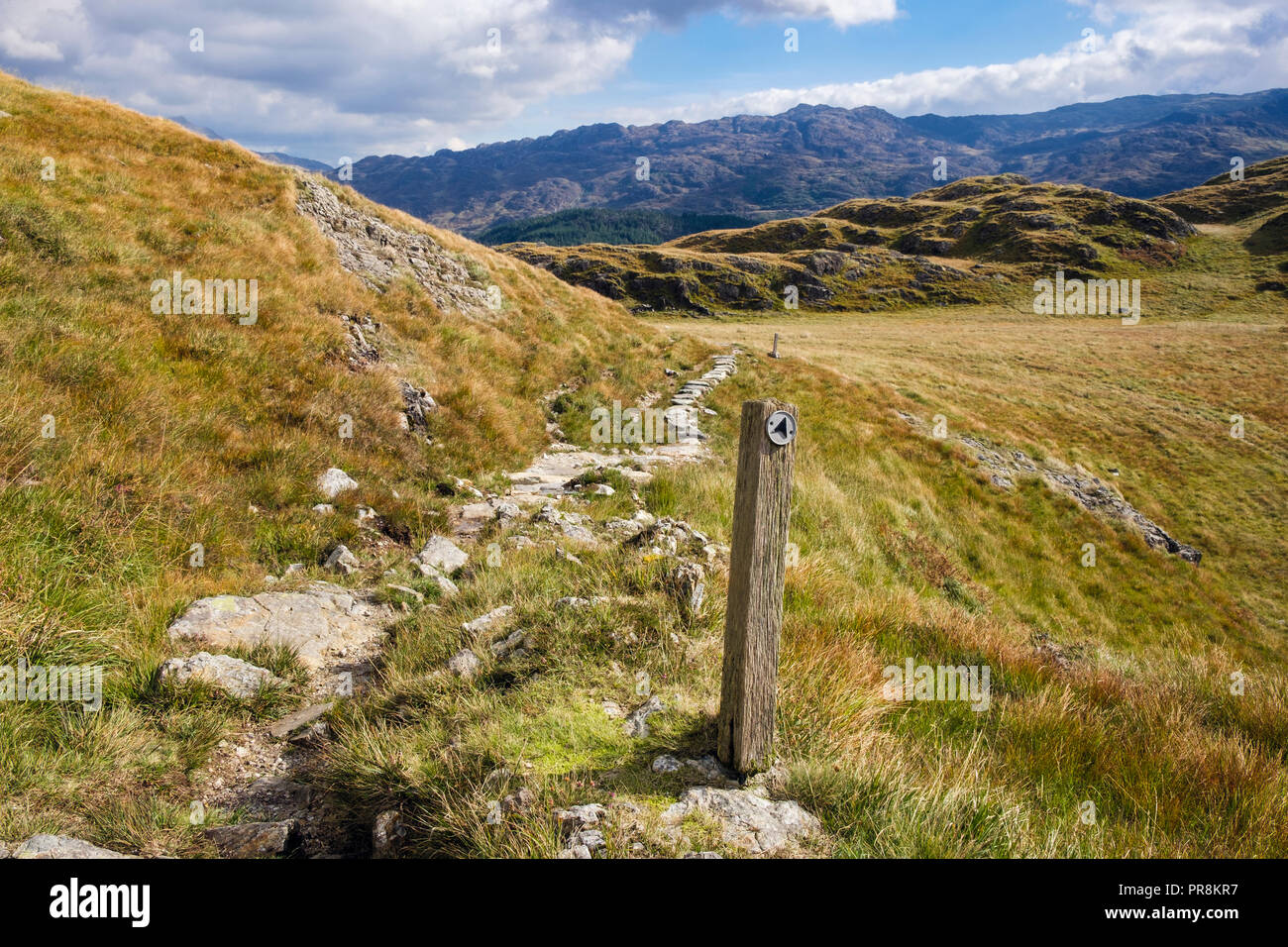 Repaired mountain path and waymarker sign in upland countryside in ...