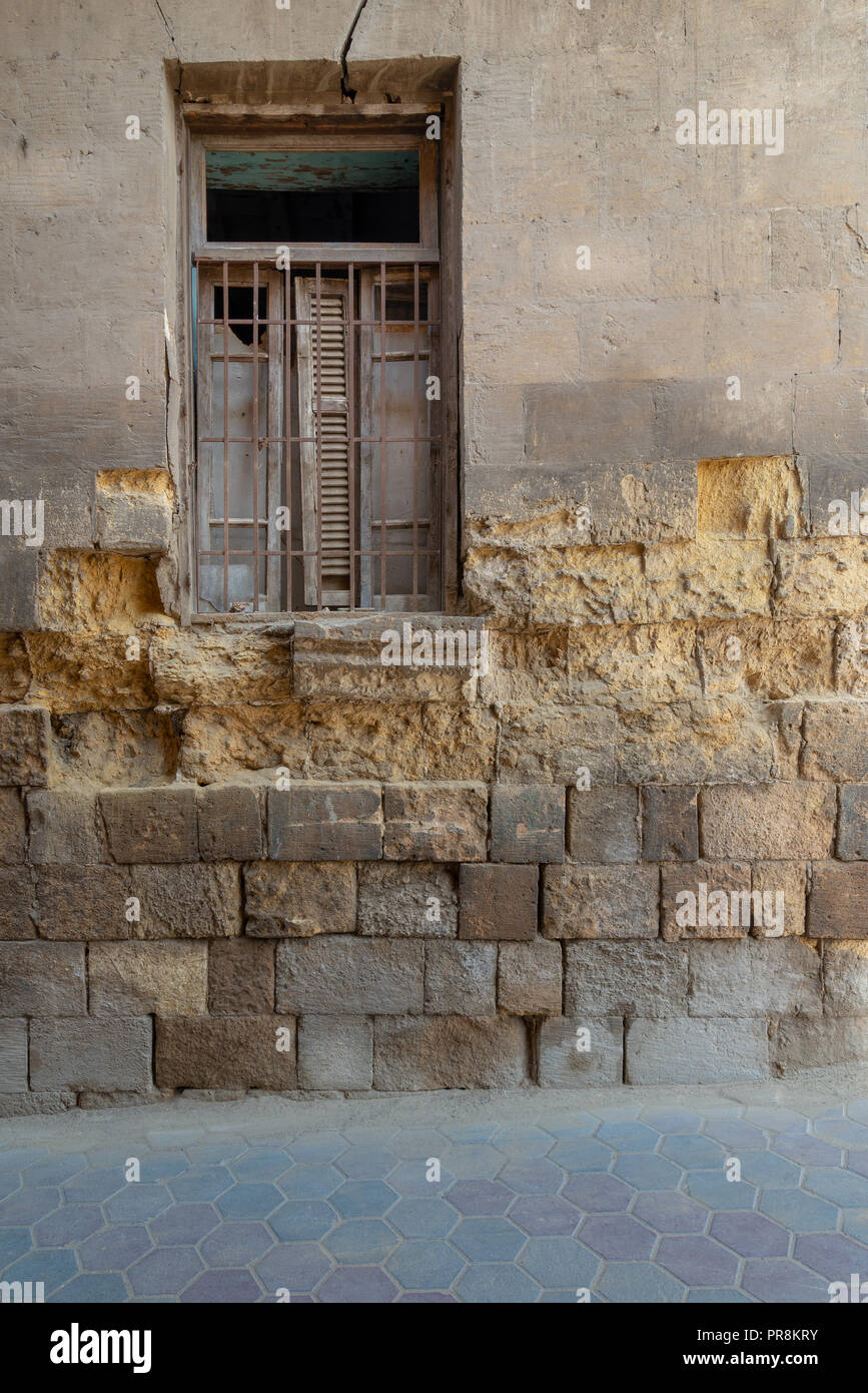 Broken windows and grunge stone bricks wall in abandoned Darb El Labana ...