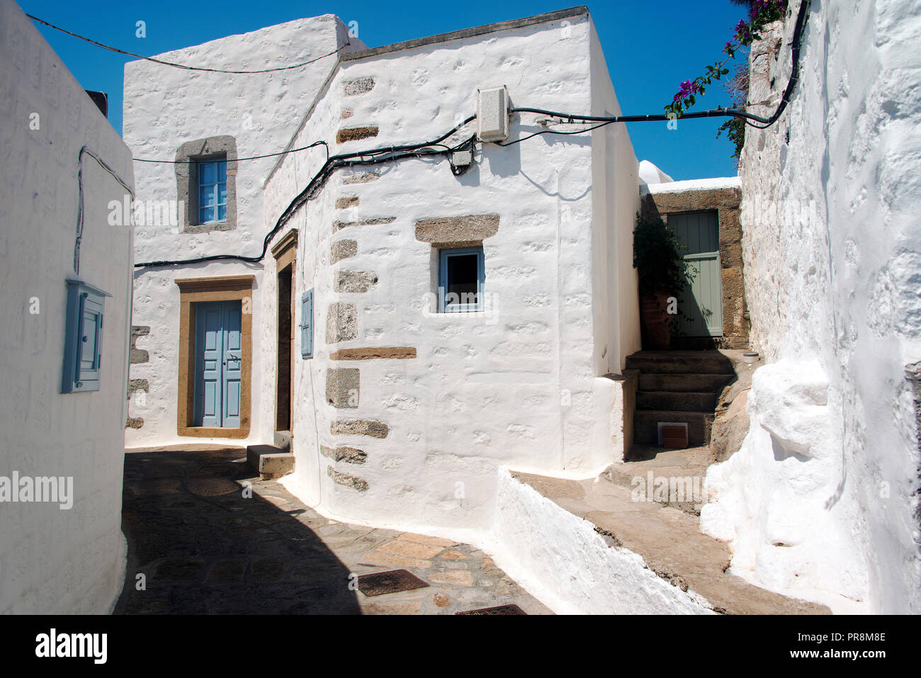 A view of streets and ancient houses in the island of Patmos, Greece in ...
