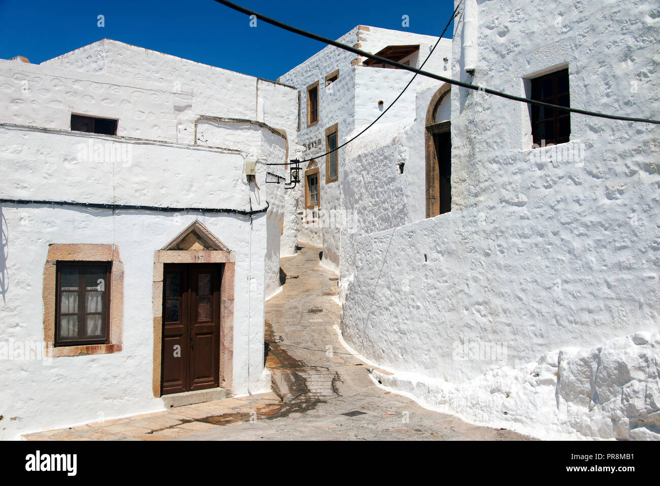 A view of streets and ancient houses in the island of Patmos, Greece in ...