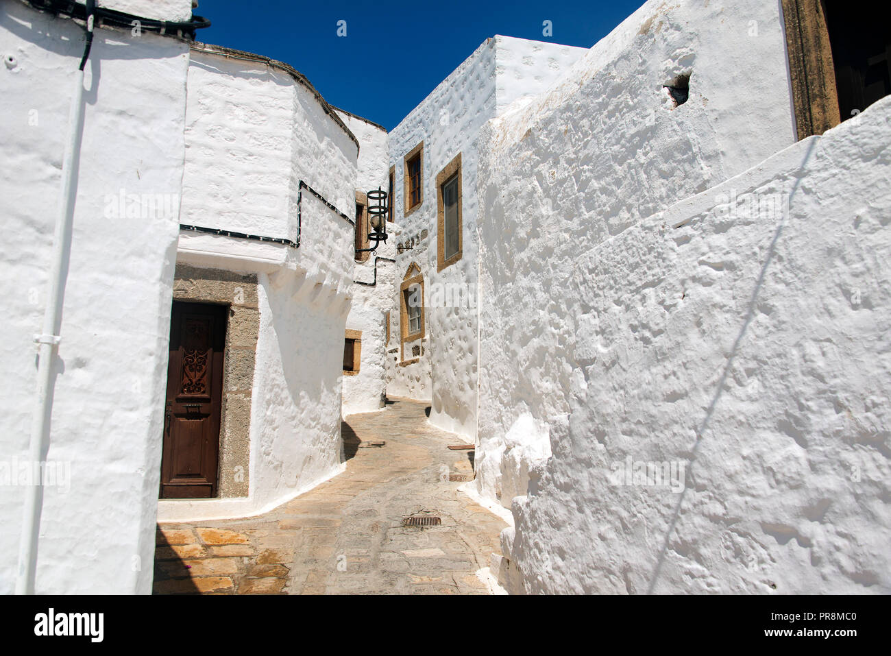 A view of streets and ancient houses in the island of Patmos, Greece in ...