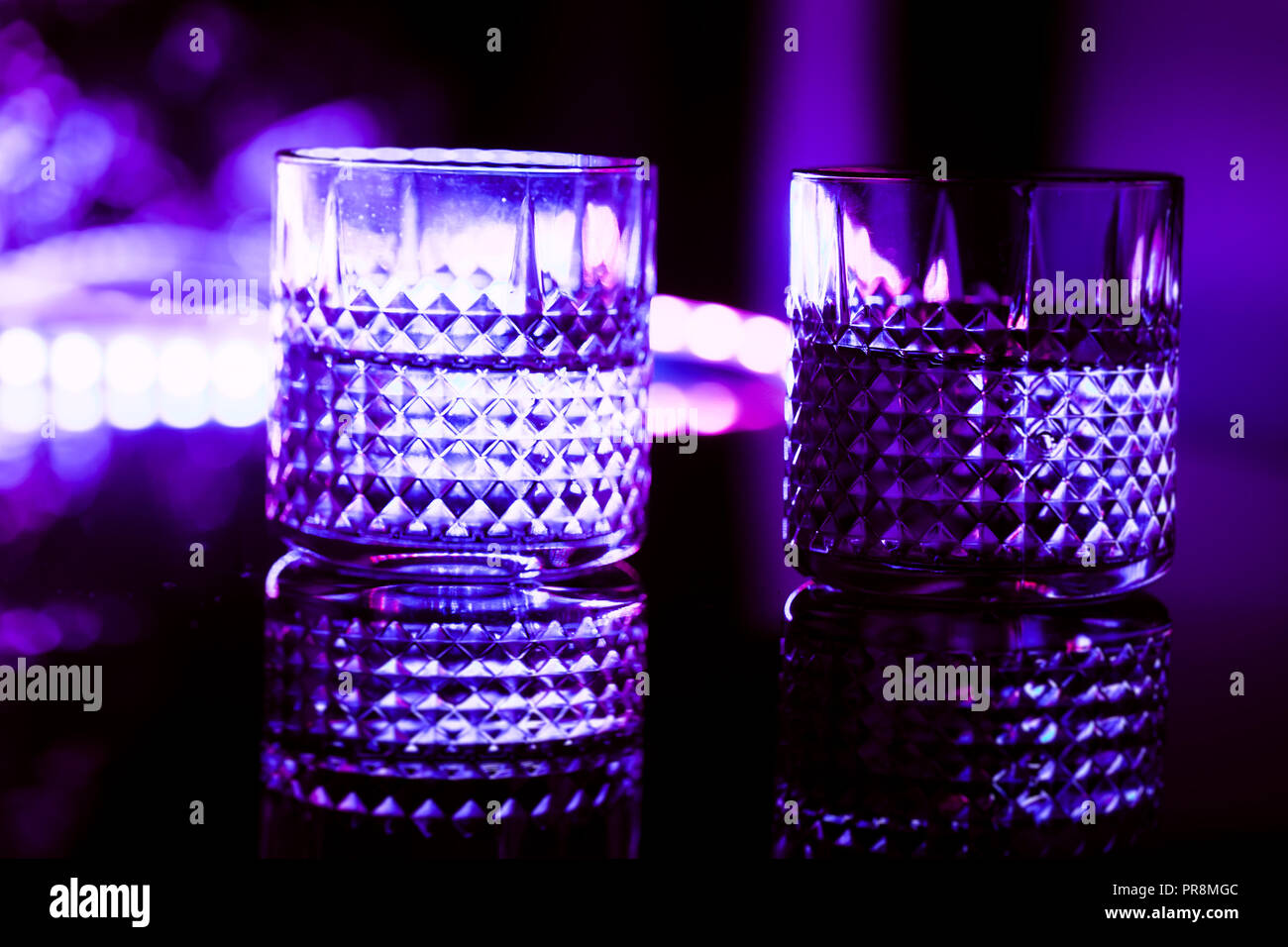 bar colored lights with glasses of alcohol Stock Photo - Alamy
