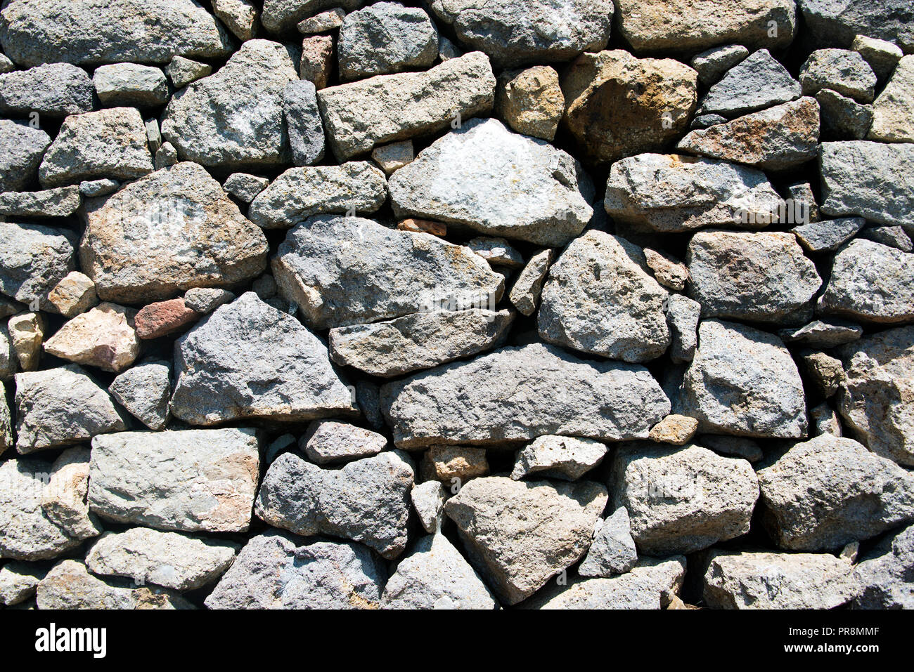 A view of a stone wall as a background Stock Photo - Alamy