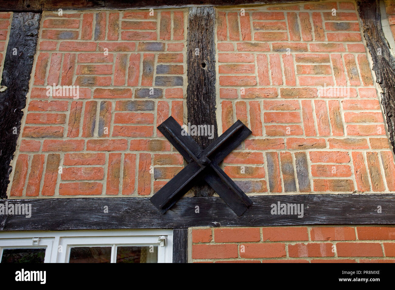 Anchor support to exterior of cottage wall Stock Photo - Alamy