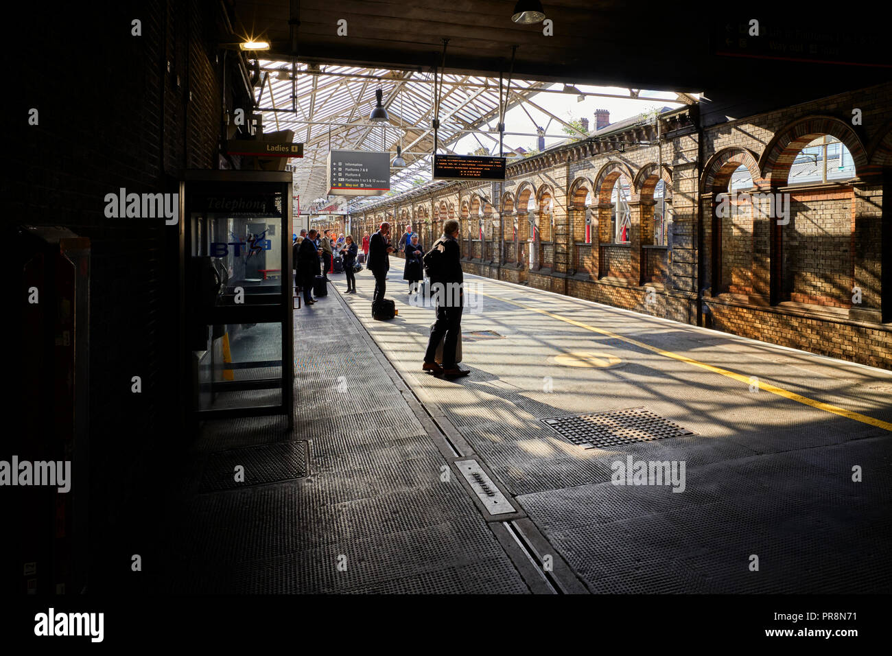 Passengers waiting for trains on platform 11 at Crewe railway station ...