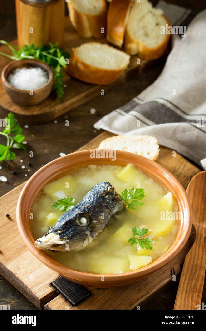 Fish soup from pike, with caviar on a wooden table in a rustic style ...