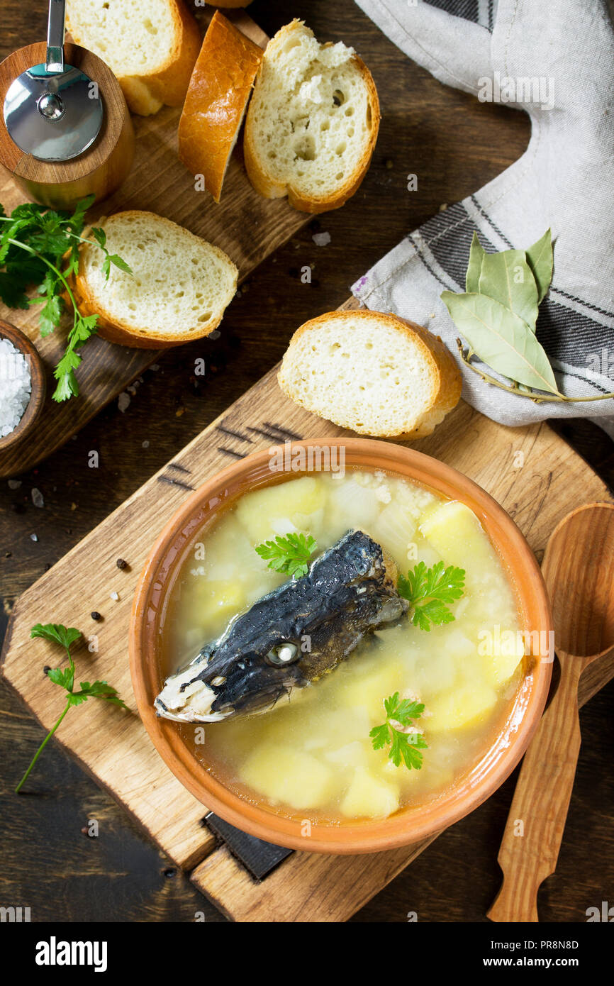 Fish soup from pike, with caviar on a wooden table in a rustic style ...