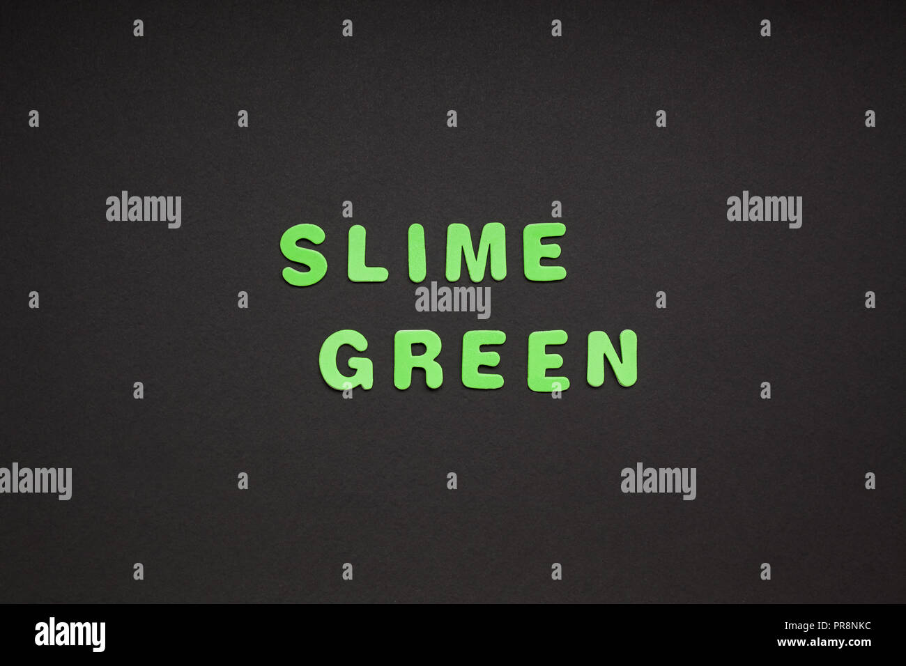 Creative colorful text made from plastic letters Slime green writing on ...