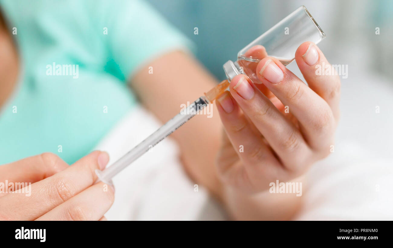 Closeup photo of woman filling syringe with medicines Stock Photo - Alamy