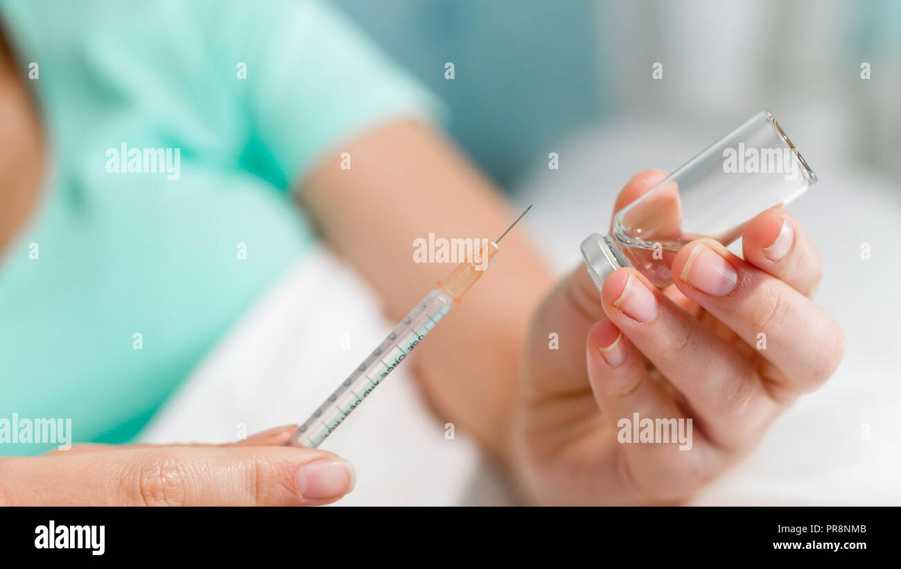 Closeup photo of nurse preparing syringe for injection Stock Photo - Alamy