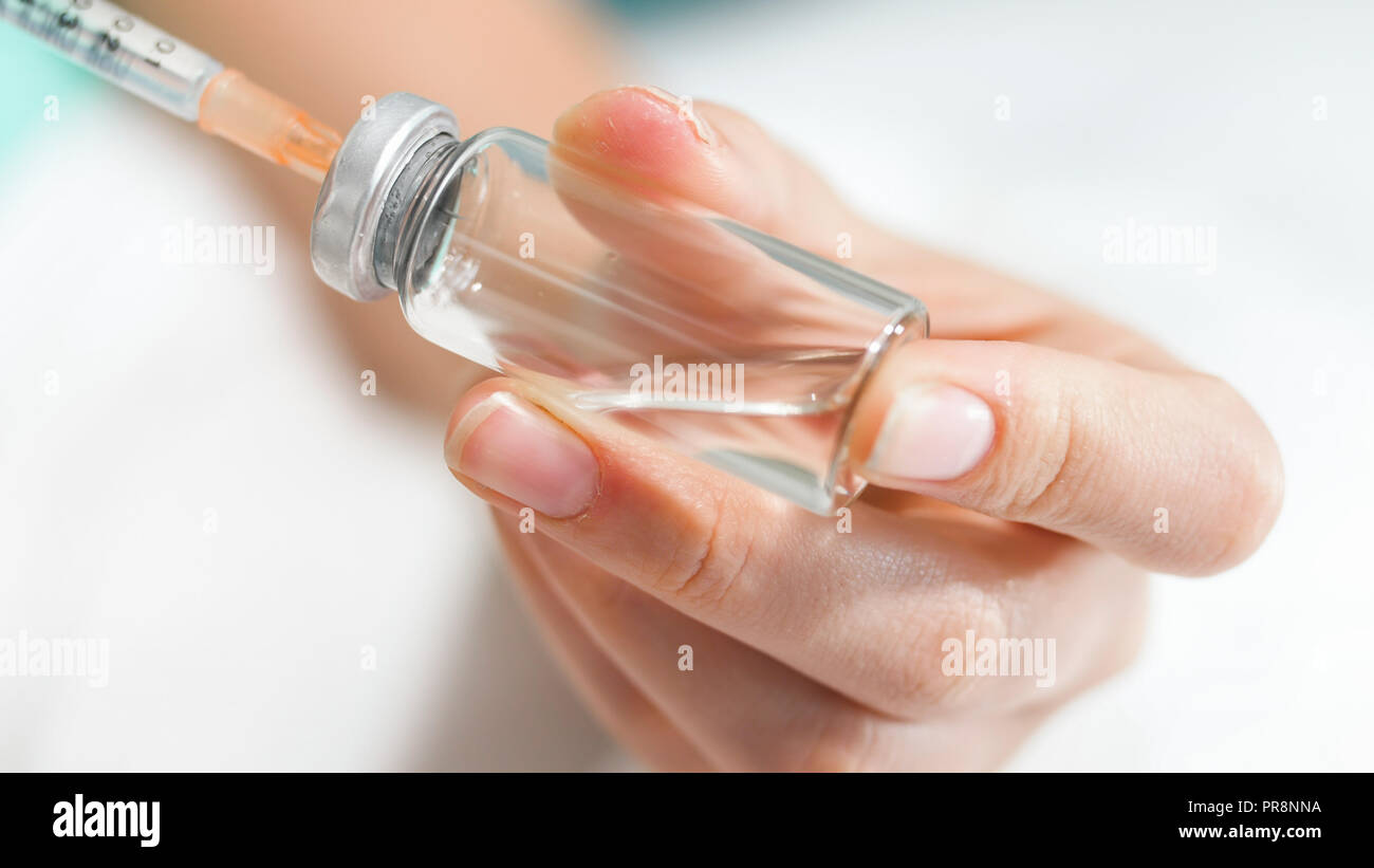 Macro image of female nurse preparing syringe for injection Stock Photo ...