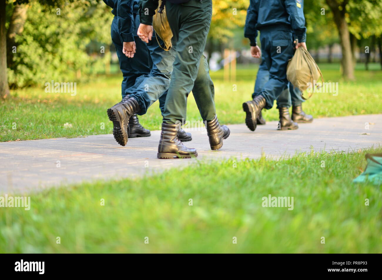 people in military uniform walking on road Stock Photo - Alamy