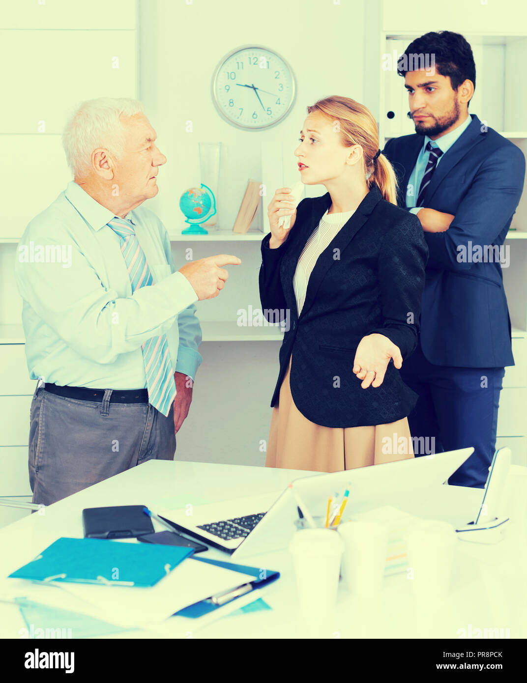 Mature boss is chastising employees because of uncompleted work in the ...