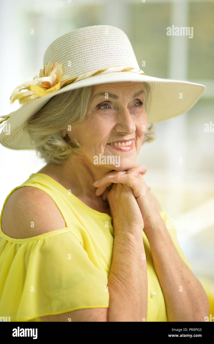 Beautiful senior woman in yellow hi-res stock photography and images ...
