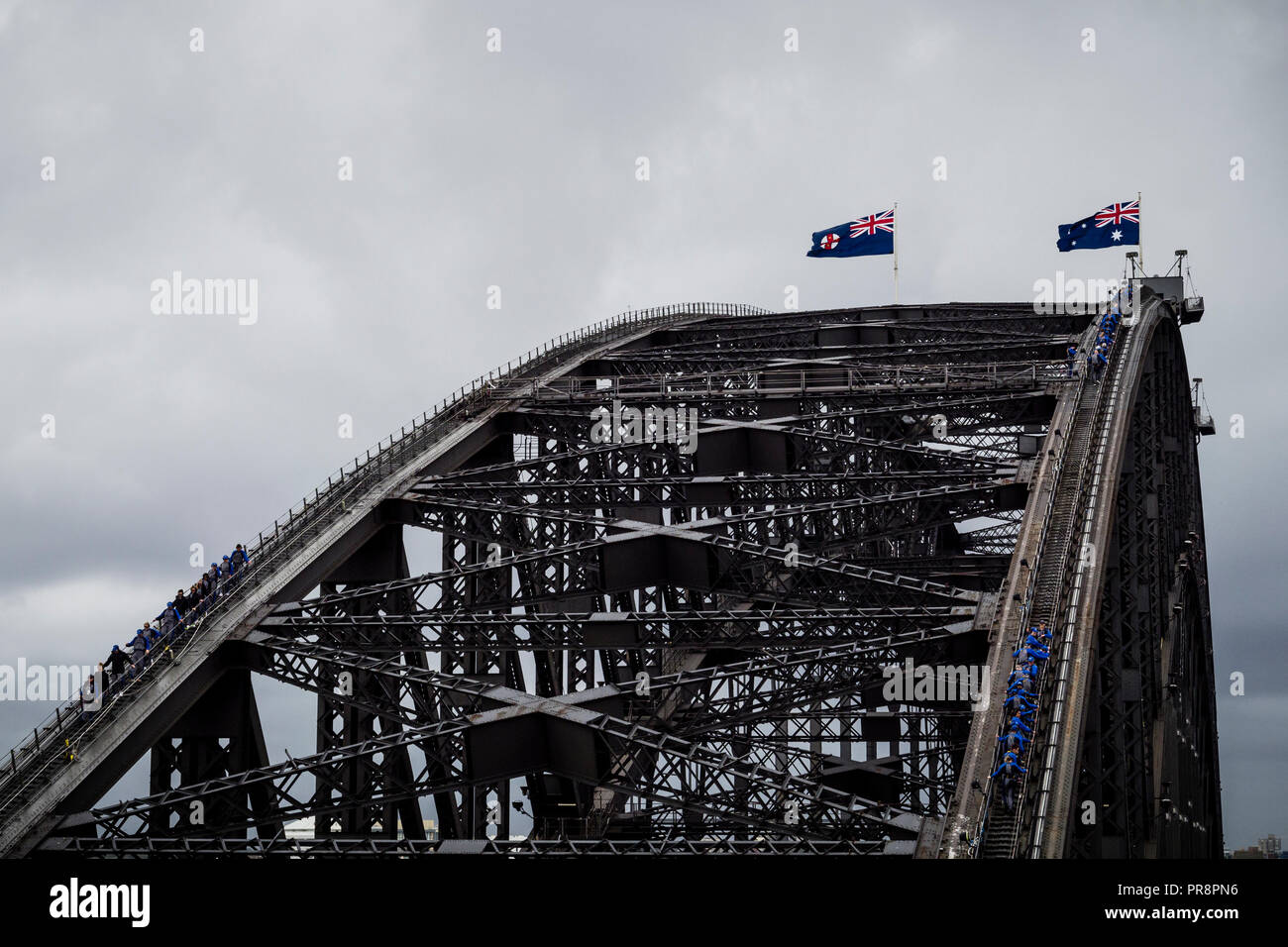People climbing to and from the summit of the Sydney Harbour Bridge ...