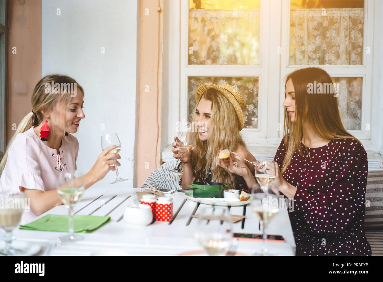 Three girls at the table Stock Photo - Alamy