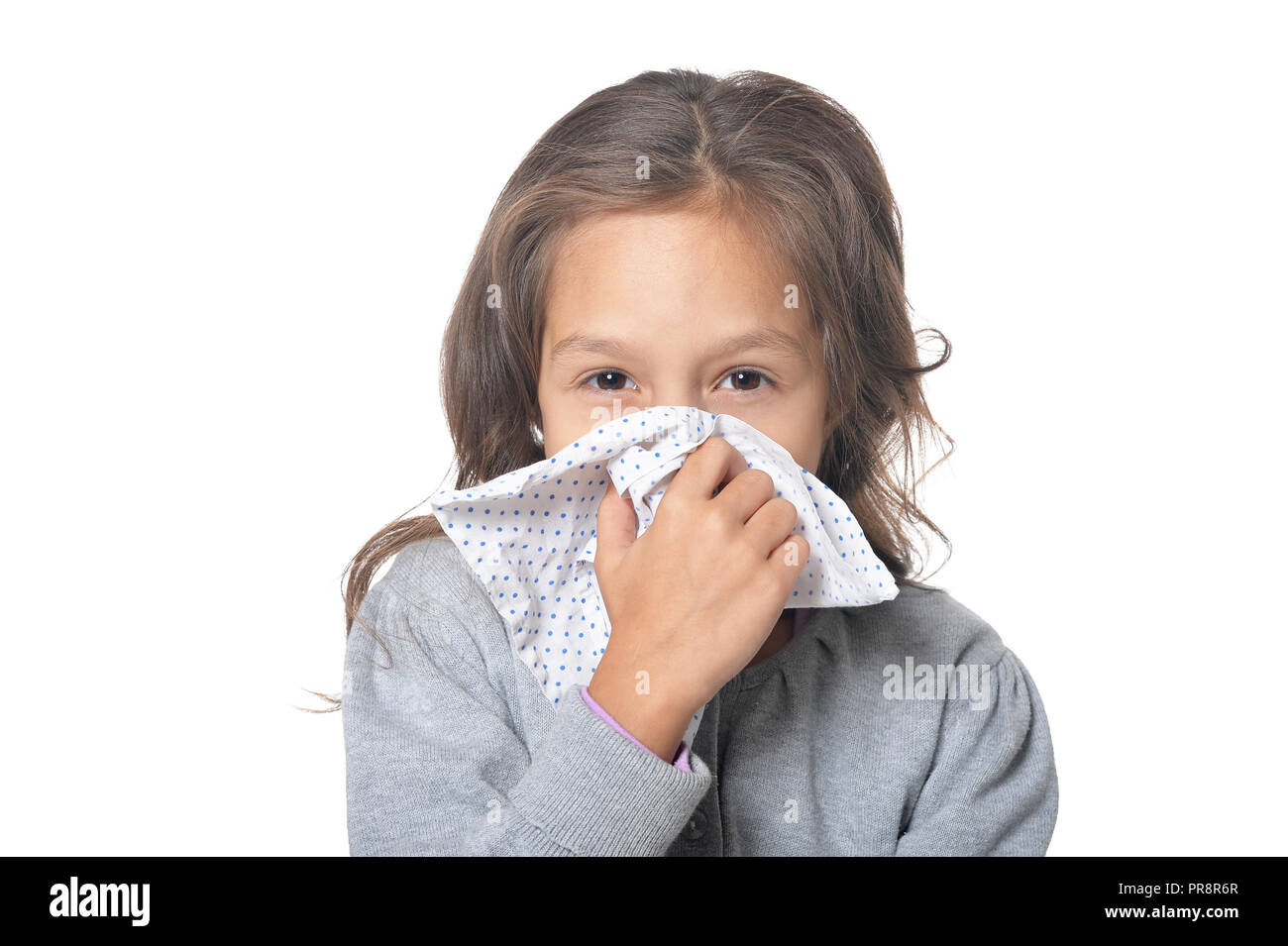 Portrait of sick little girl holding handkerchief Stock Photo - Alamy