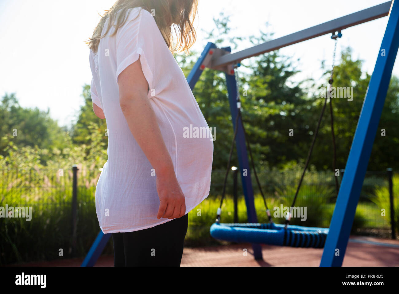 lonely pregnant woman on the playground Stock Photo - Alamy