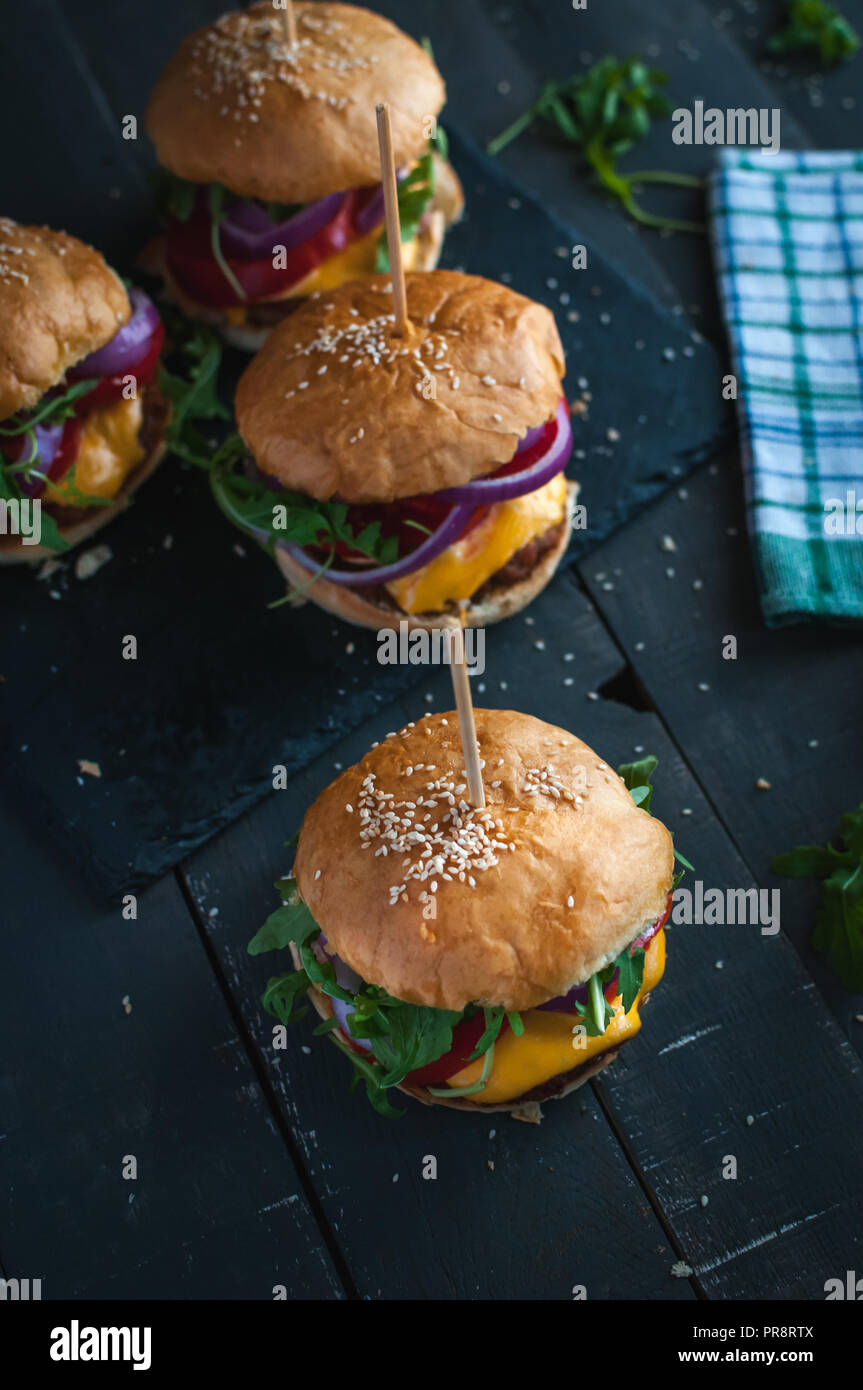 Homemade fresh burgers on dark background Stock Photo - Alamy