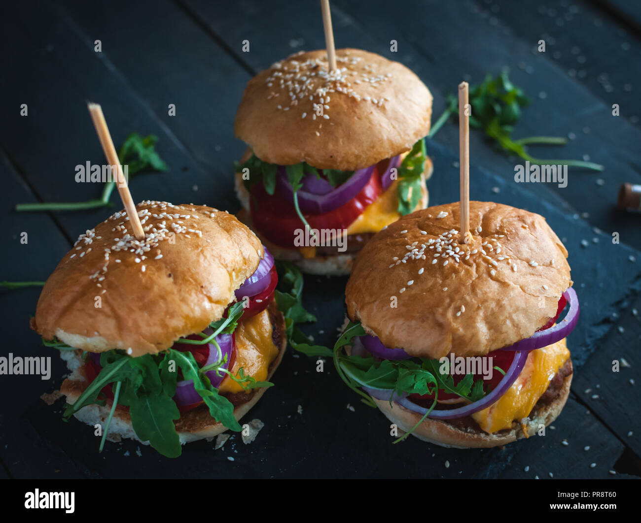 Homemade fresh burgers on dark background Stock Photo - Alamy