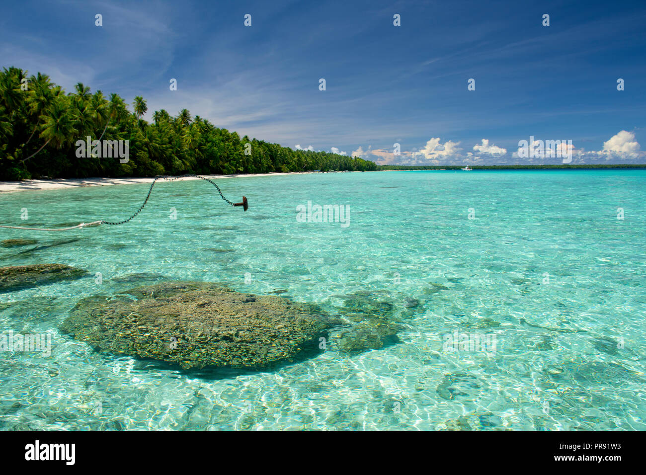 Anchor being thrown in a white sand beach at Ant Atoll, Pohnpei ...