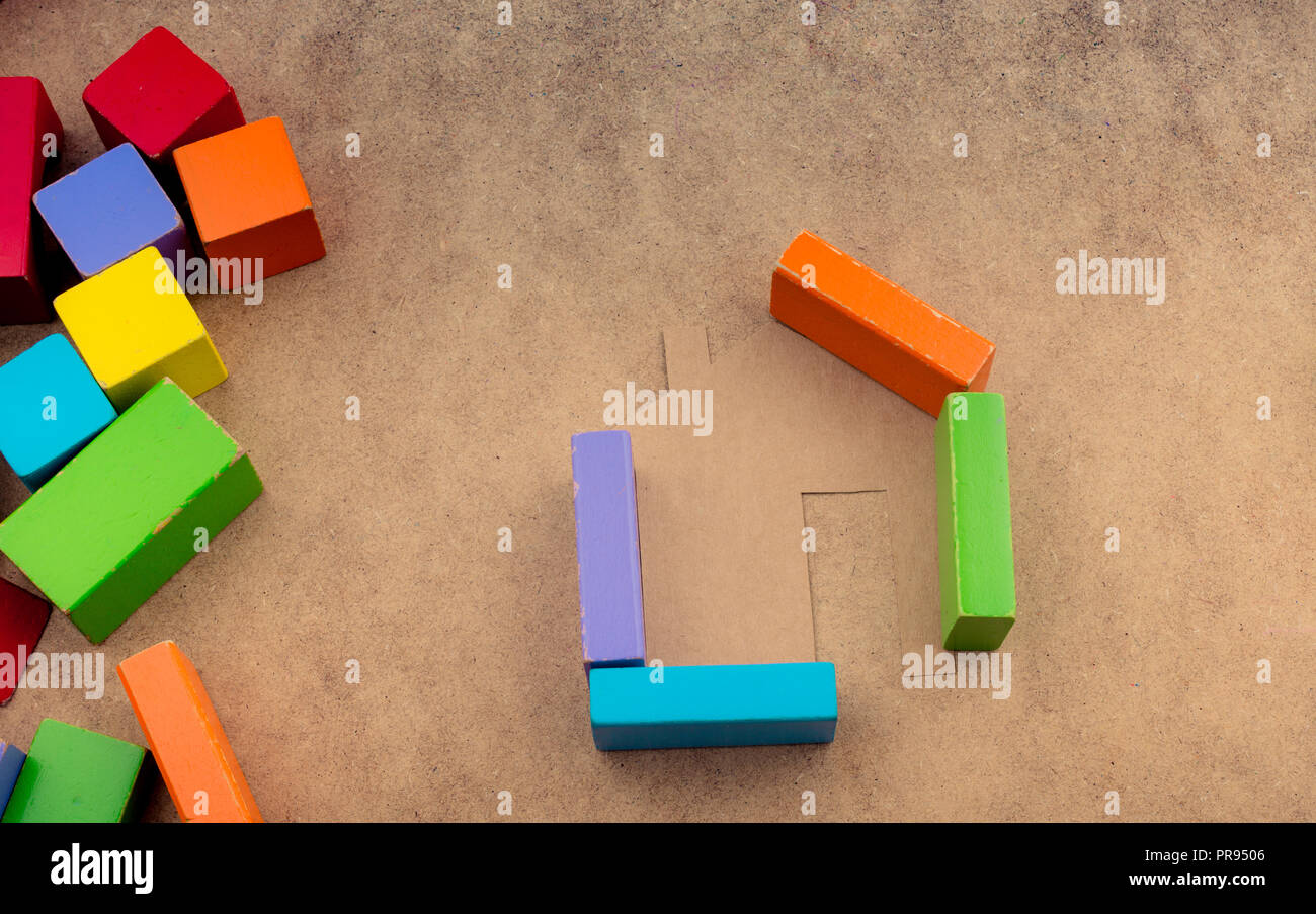 House shape formed out of building blocks on a brown background Stock ...
