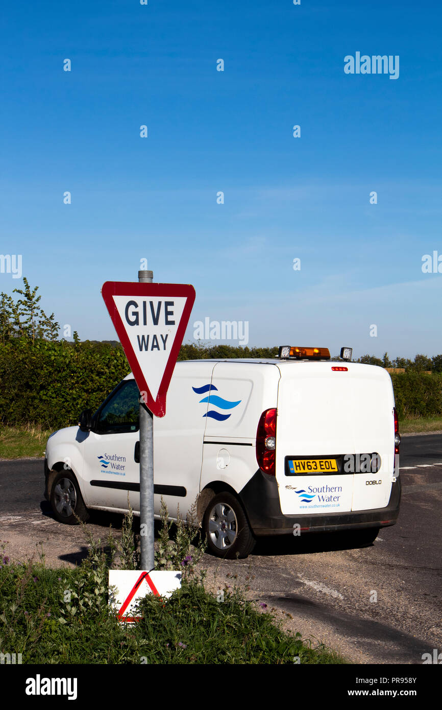 give way road sign on country lane joining main highway junction in ...
