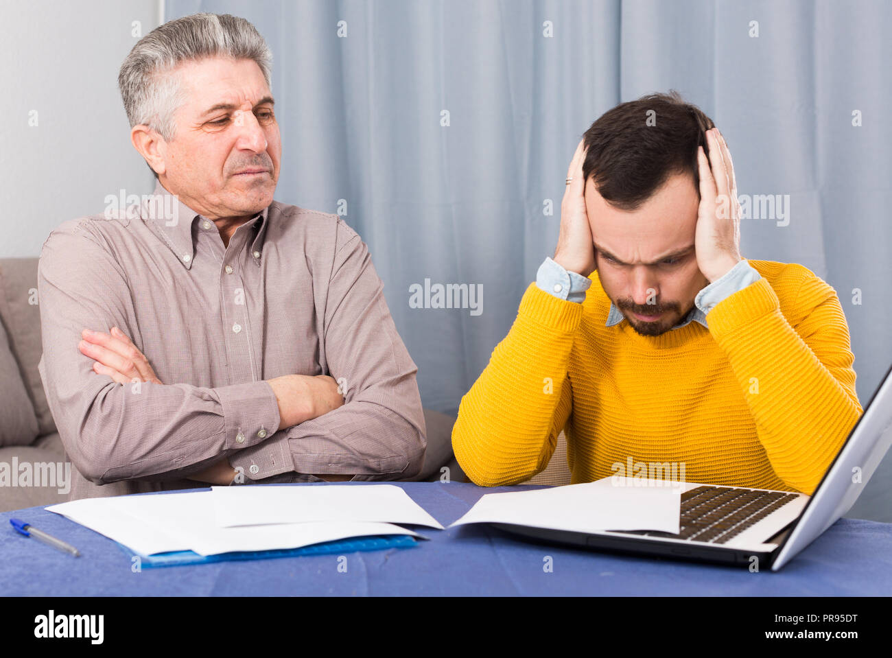 Son and father signing documents hi-res stock photography and images ...