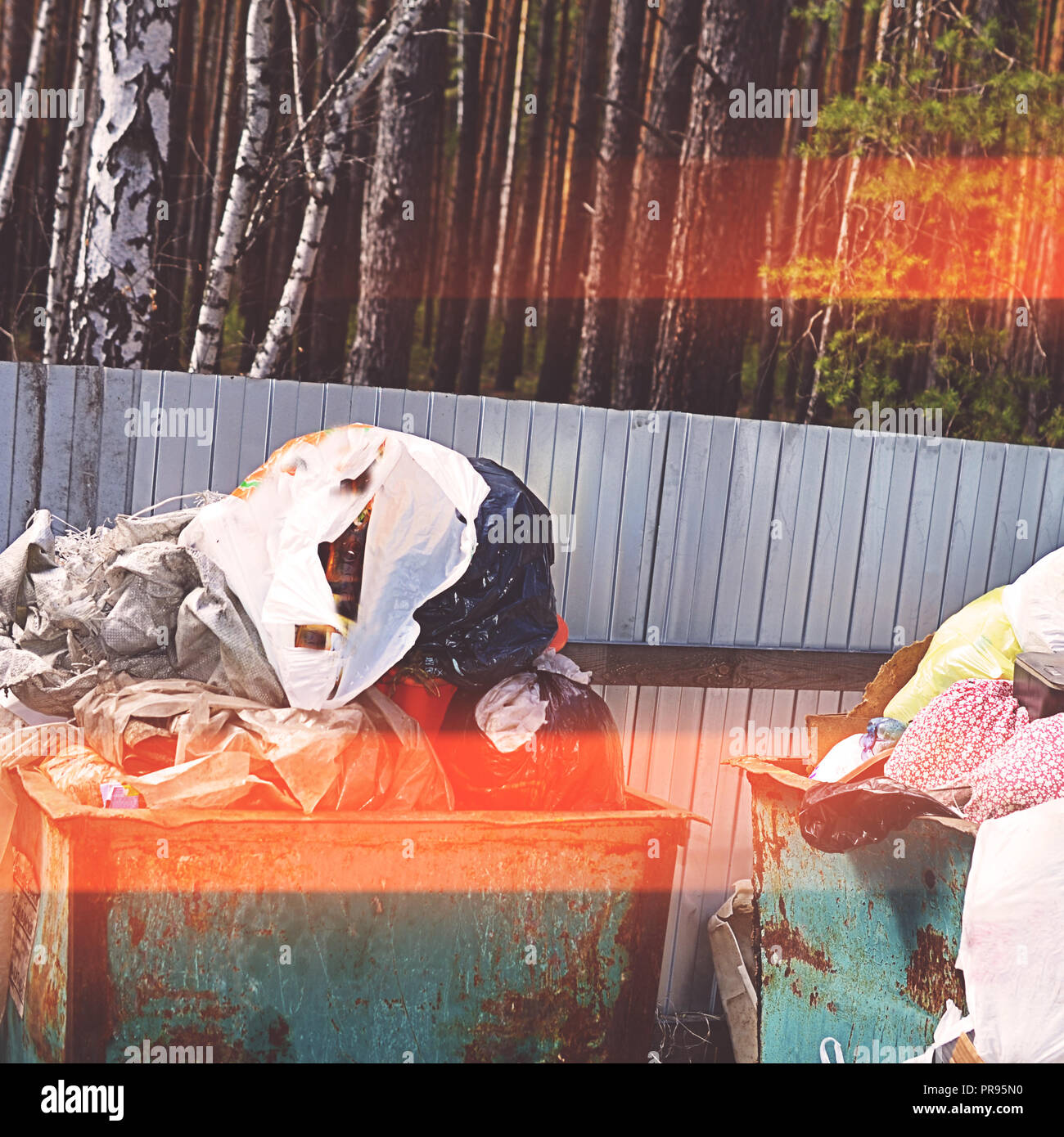 Litter box full of garbage in forest. Concept of ecology problem. Toned ...