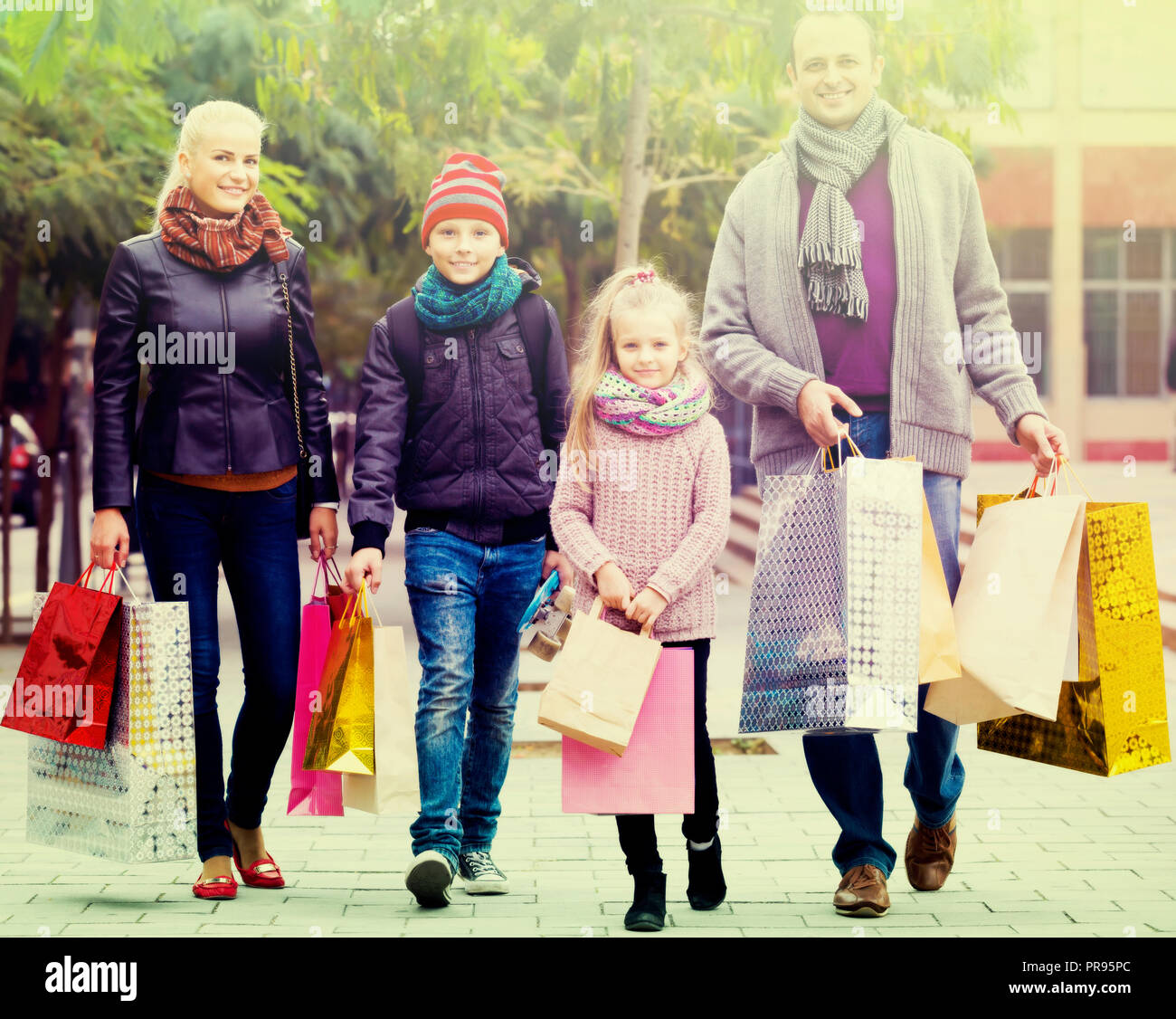 Happy parents with school age children enjoying shopping tour Stock ...